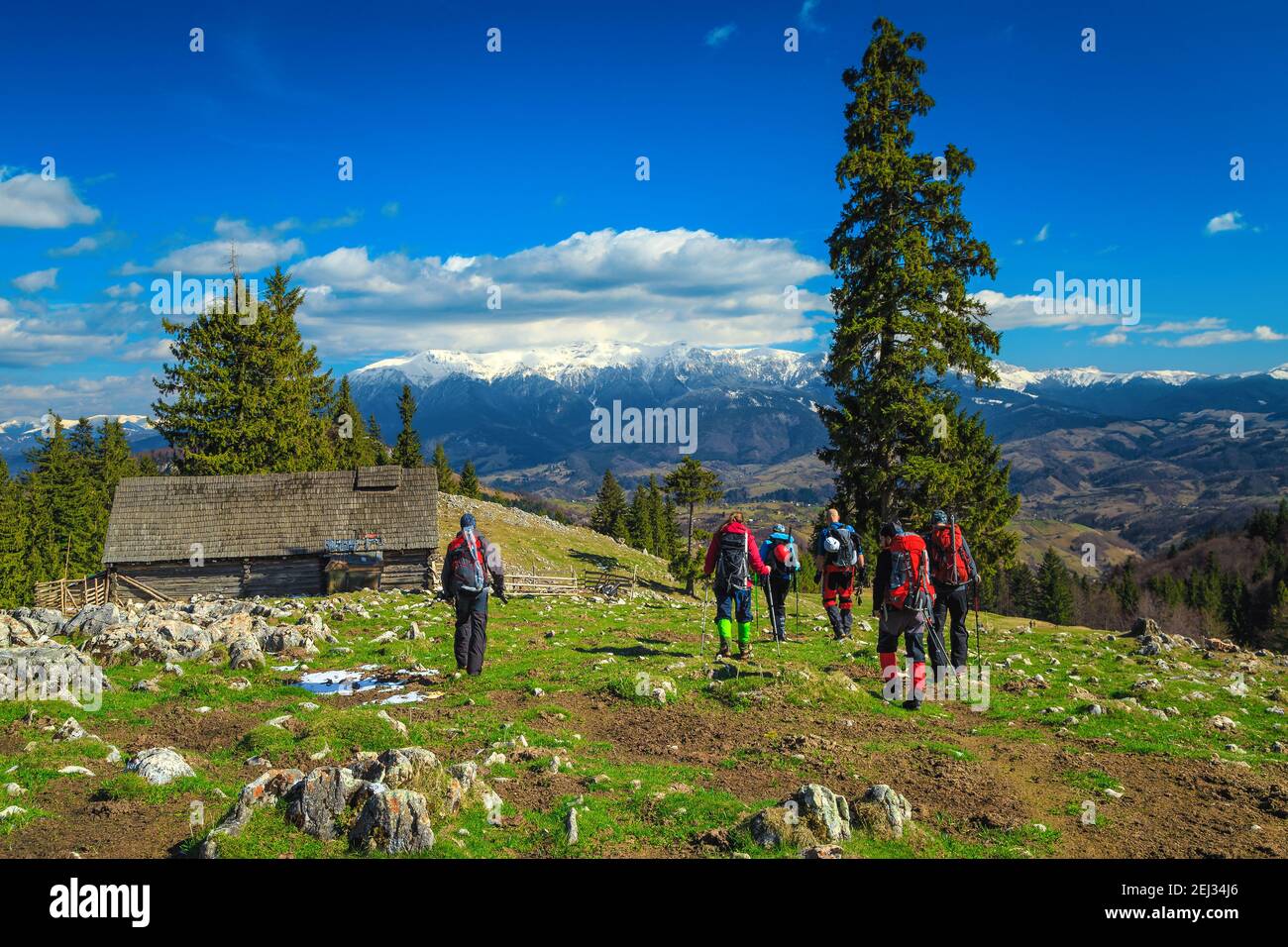 Tired climbers walking down from the snowy mountain, Piatra Craiului ...
