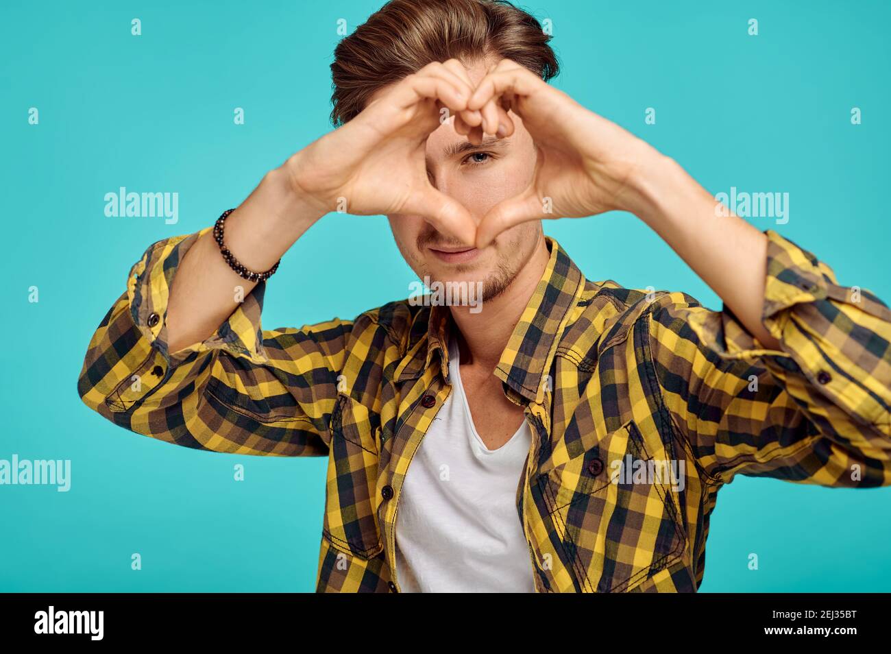 Smiling young man shows heart hi-res stock photography and images - Alamy