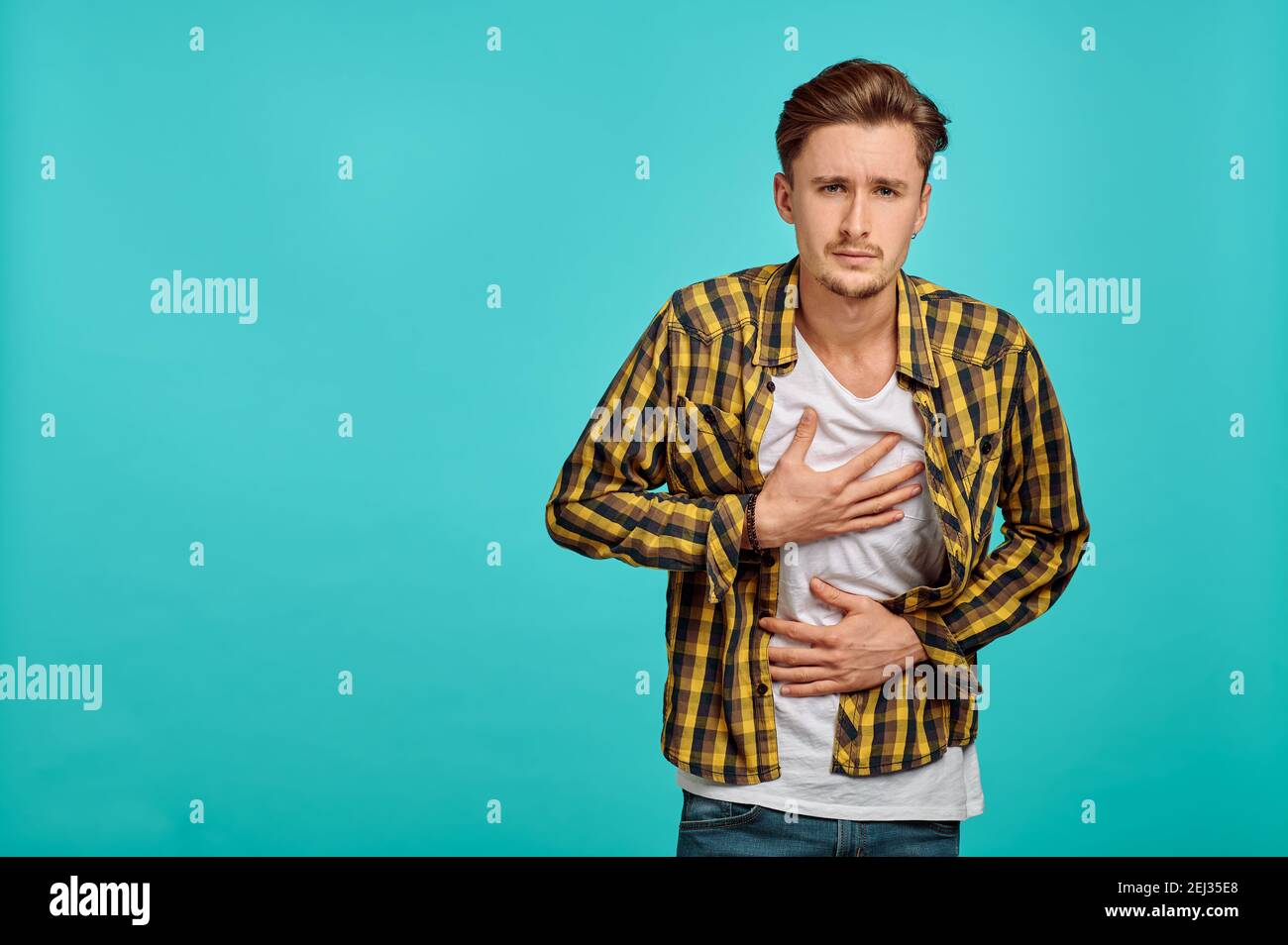 Young sick man portrait, blue background, emotion Stock Photo - Alamy