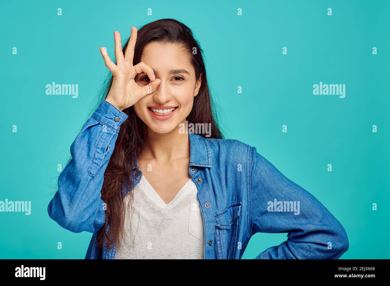 Cute young woman shows ok dign, positive emotion Stock Photo - Alamy