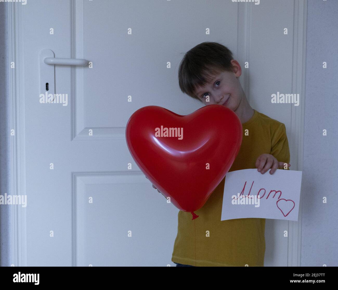 Happy kid boy hold a heart . Happy mother's day Stock Photo - Alamy