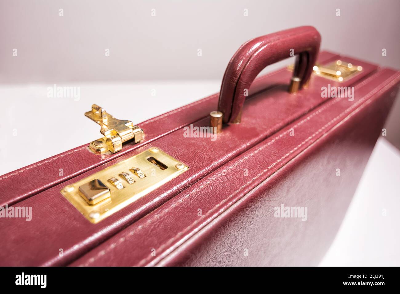 Closed 24 hour briefcase with open lock Stock Photo - Alamy