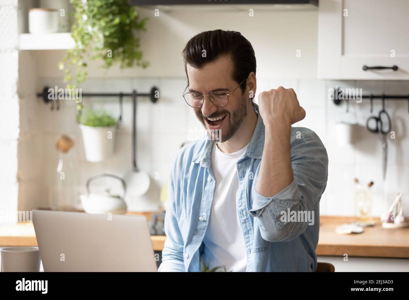 Excited millennial man triumph hi-res stock photography and images - Alamy
