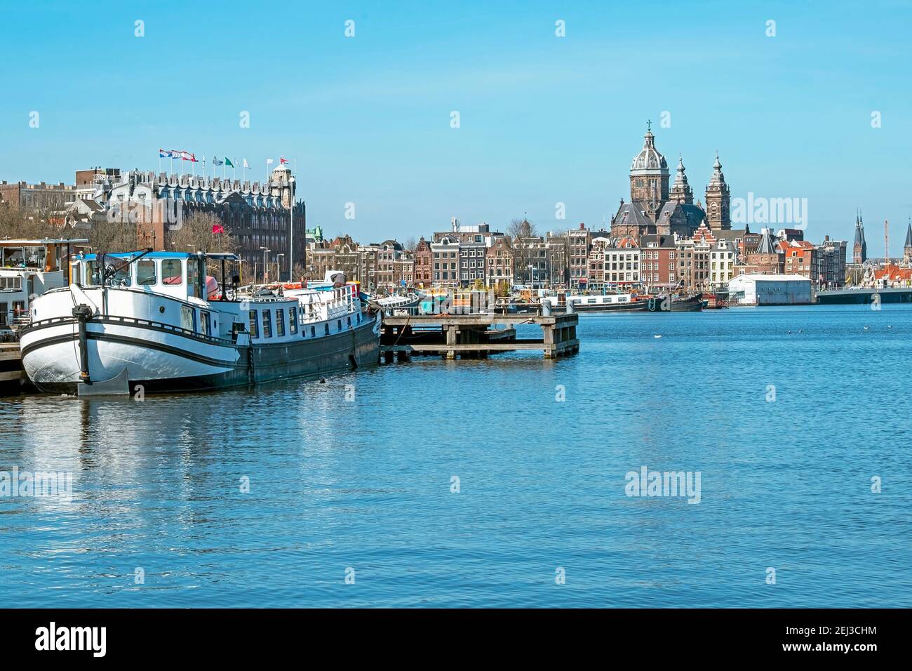 City scenic from the harbor of Amsterdam in the Netherlands with the St ...