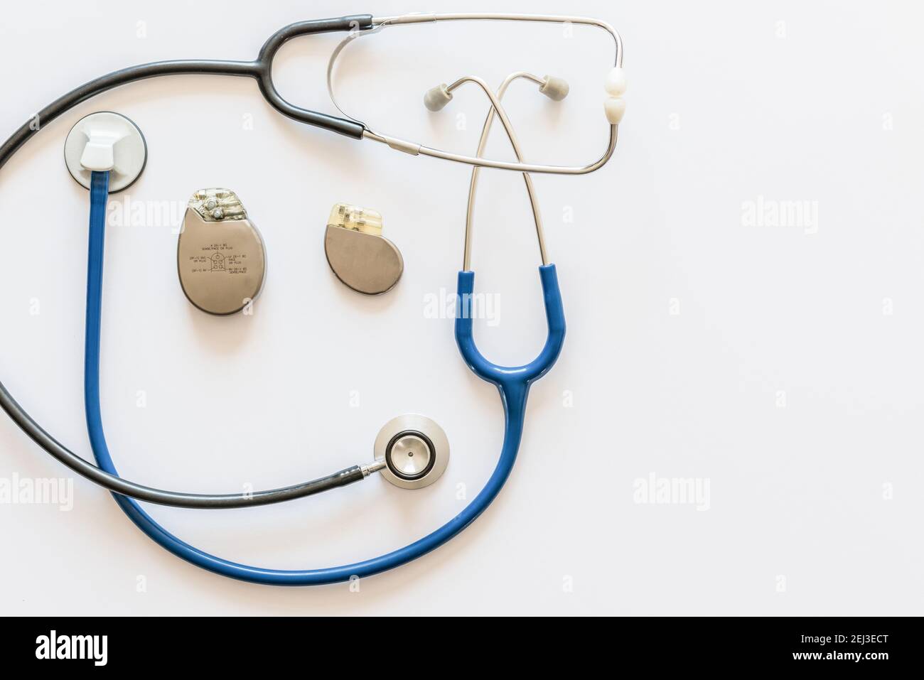 two blue and black stethoscopes on a white background with pacemaker ...