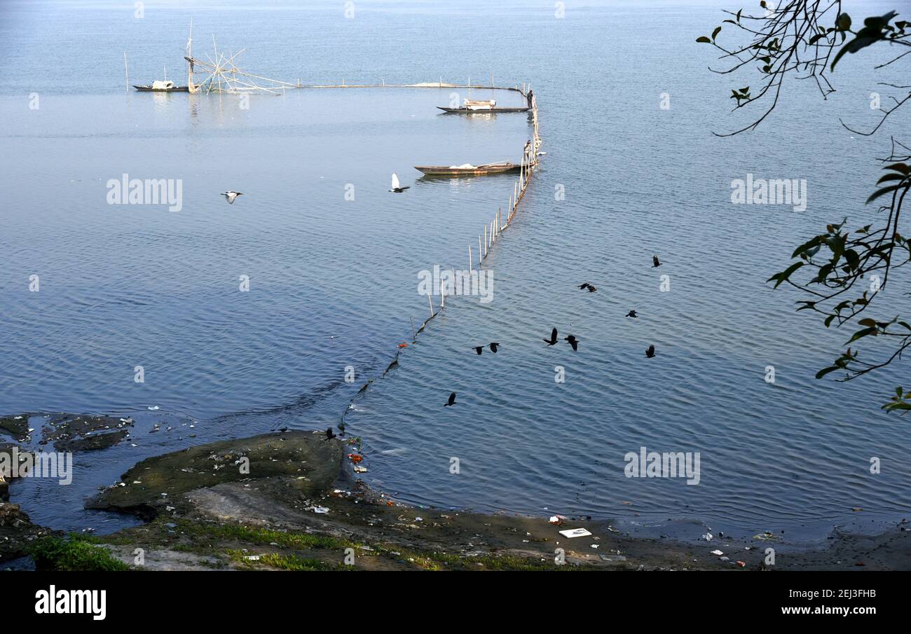 Guwahati, Assam, India. 20th Feb, 2021. Fishermen catch fish in river ...