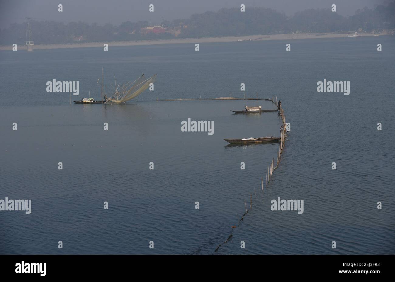 Guwahati, Assam, India. 20th Feb, 2021. Fishermen catch fish in river ...