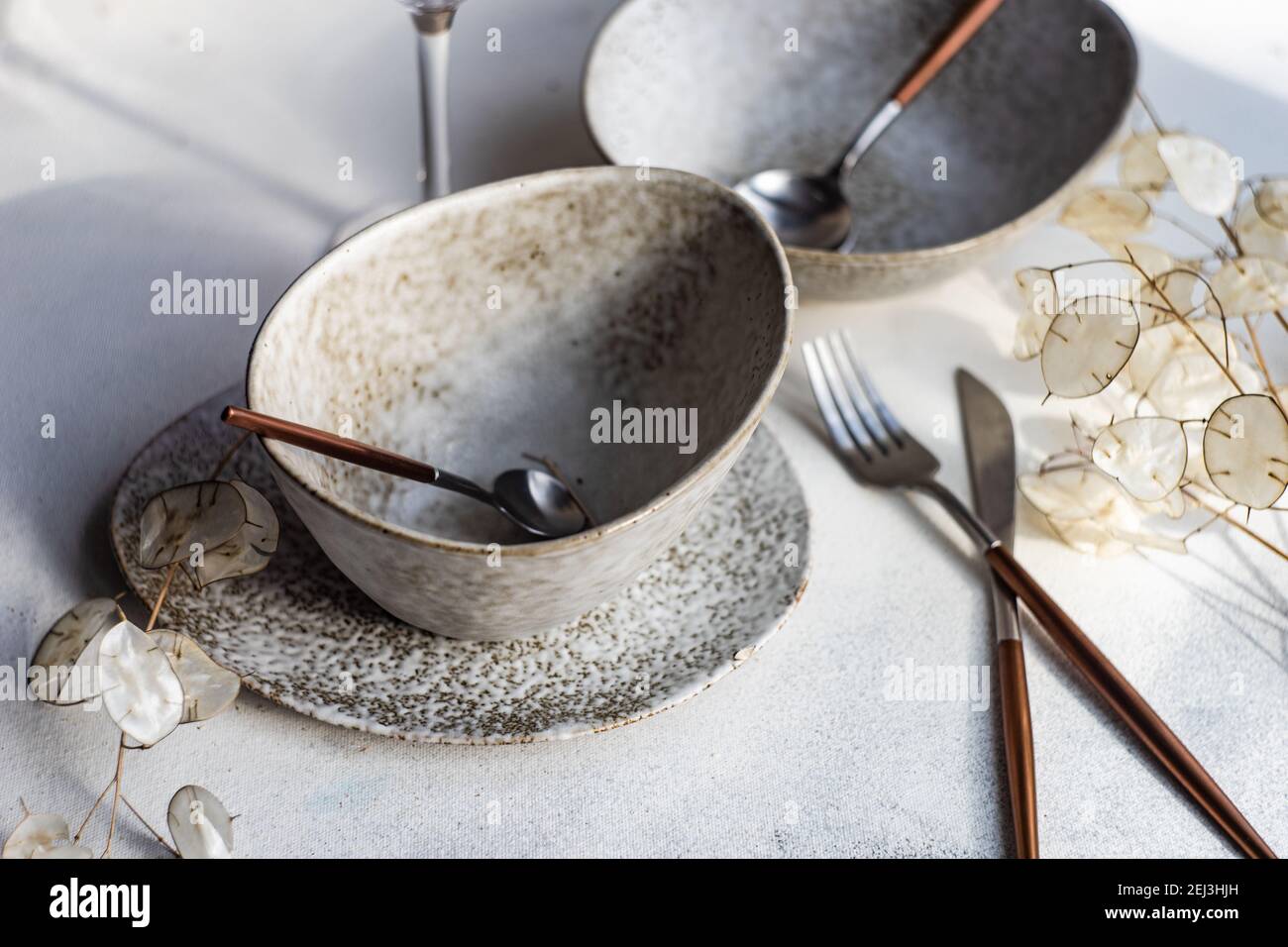 Minimalistic table setting in pastel colors on white concrete ...
