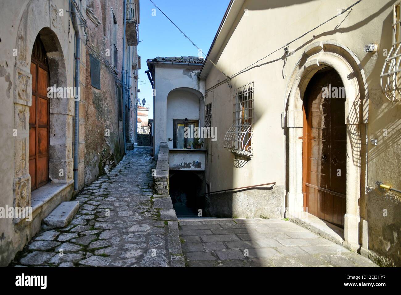 A street among the old stone houses of Montefusco, a medieval village ...