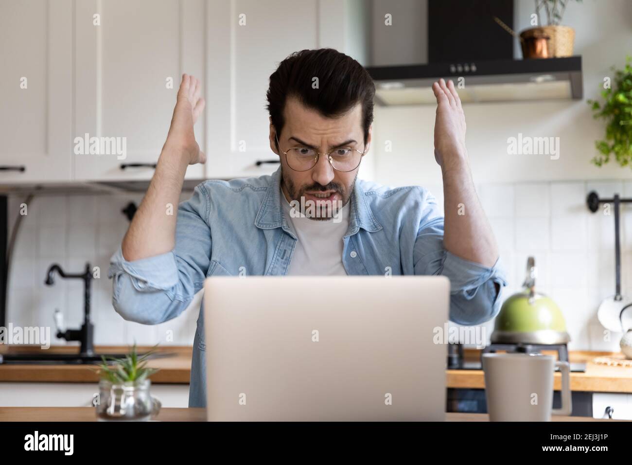 Angry man look at laptop screen frustrated by gadget problem Stock ...