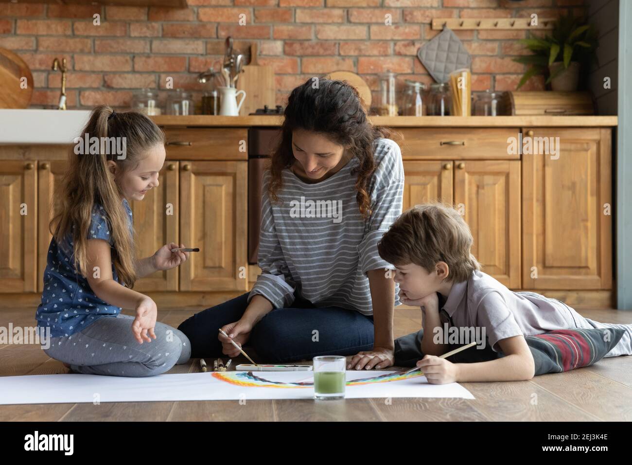 Caring young mother and two kids playing, painting watercolor Stock ...