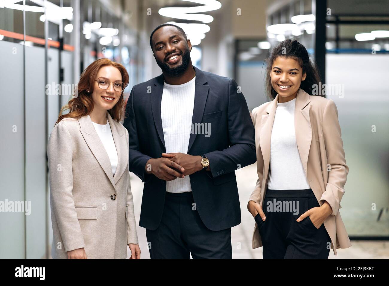 Confident successful colleagues stand in modern office. Portrait of ...