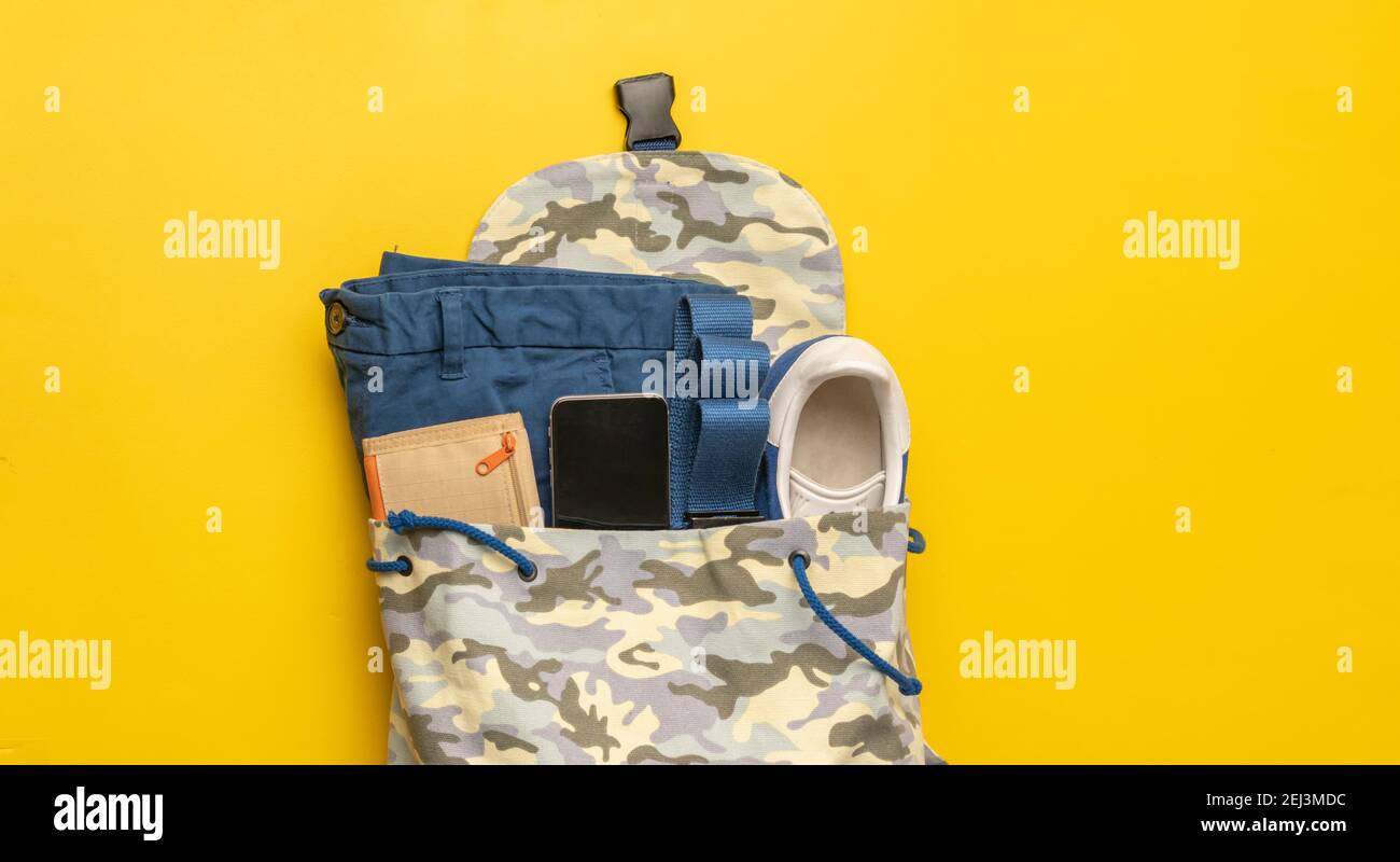 a view from above on casual simple backpack with things and clothes ...