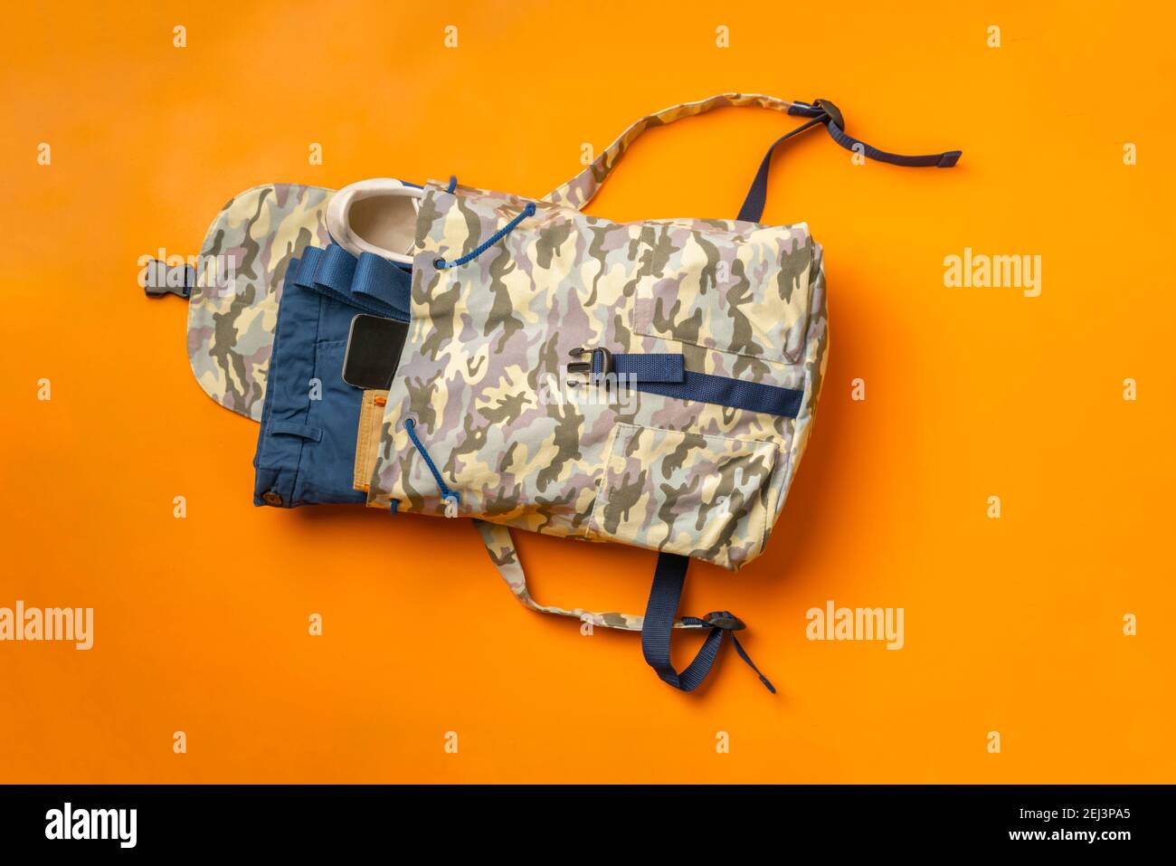 a view from above on casual simple backpack with things and clothes ...