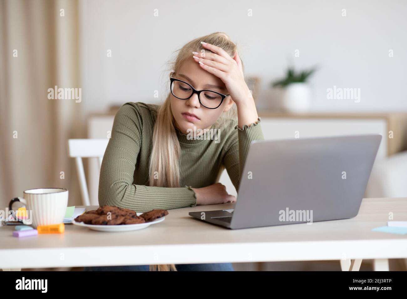 Upset teen girl feeling lonely while staying home alone Stock Photo - Alamy