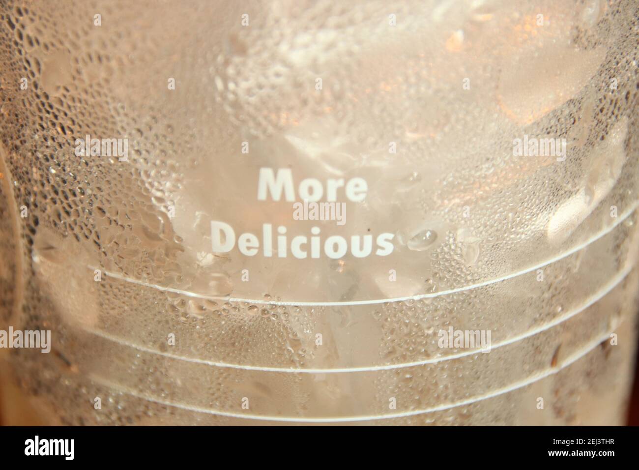 A closeup shot of a plastic bottle with More Delicious print Stock ...