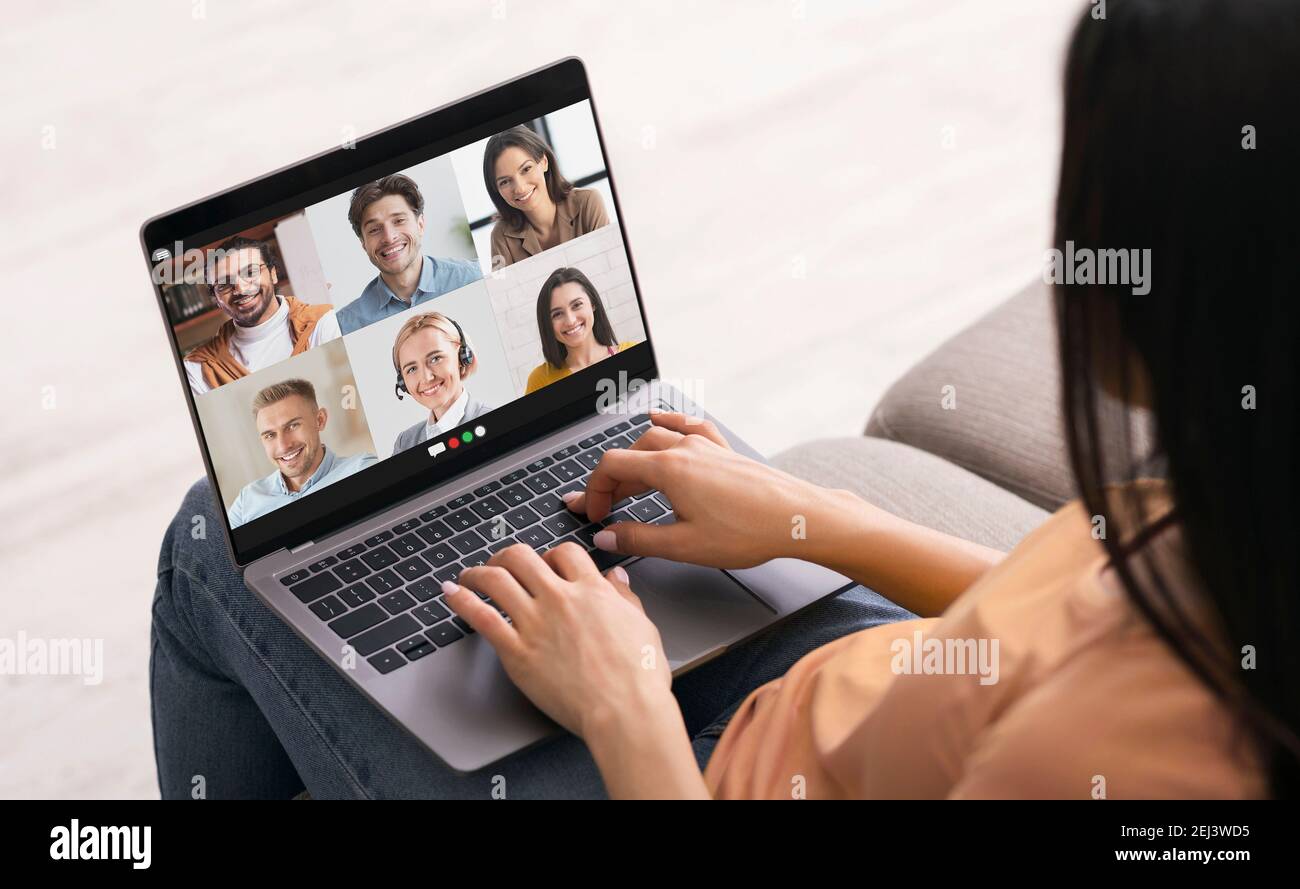 Distance communication. Young woman having online group conference with ...