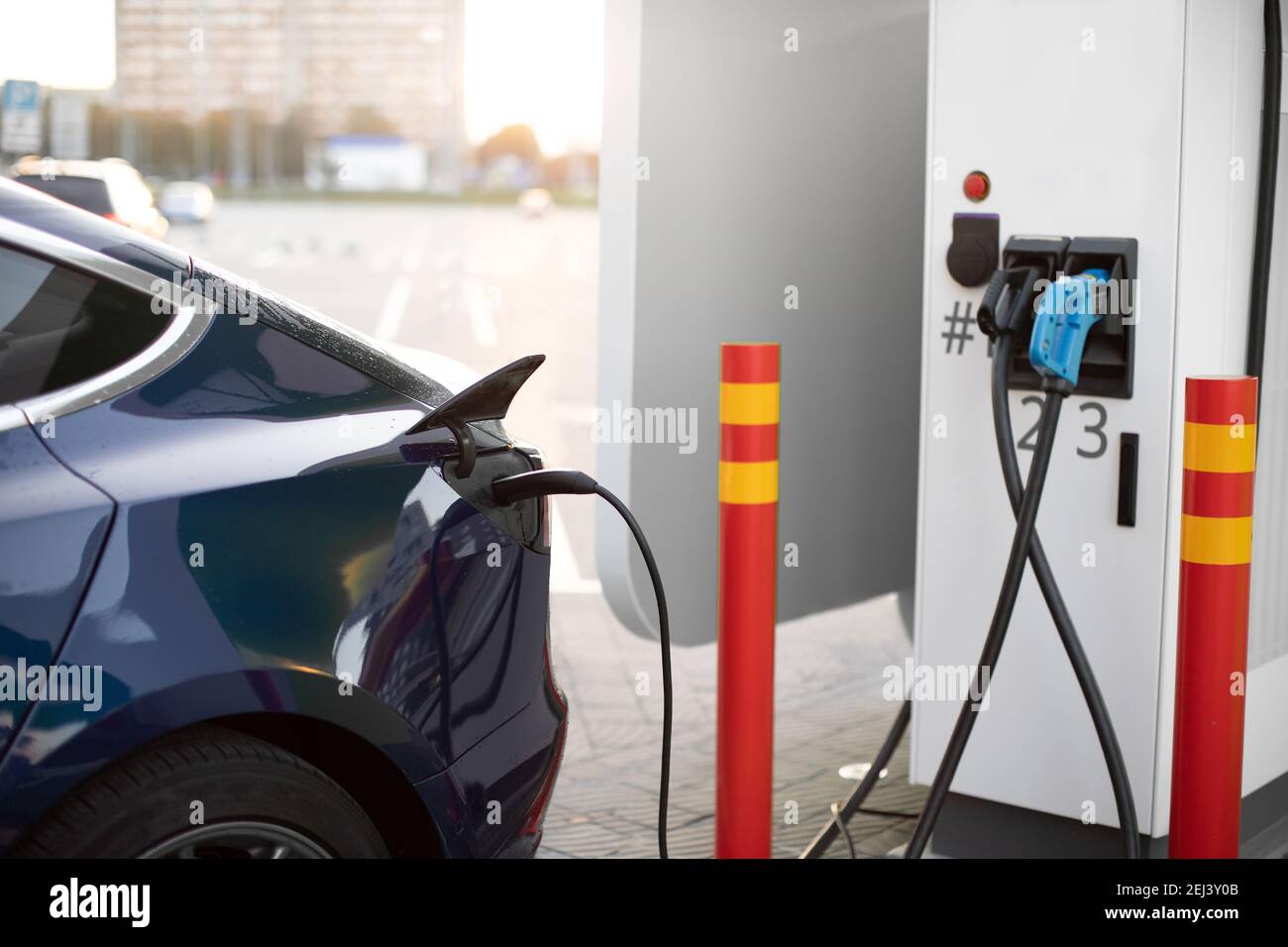 Power supply connect to modern blue electric car for recharging the ...