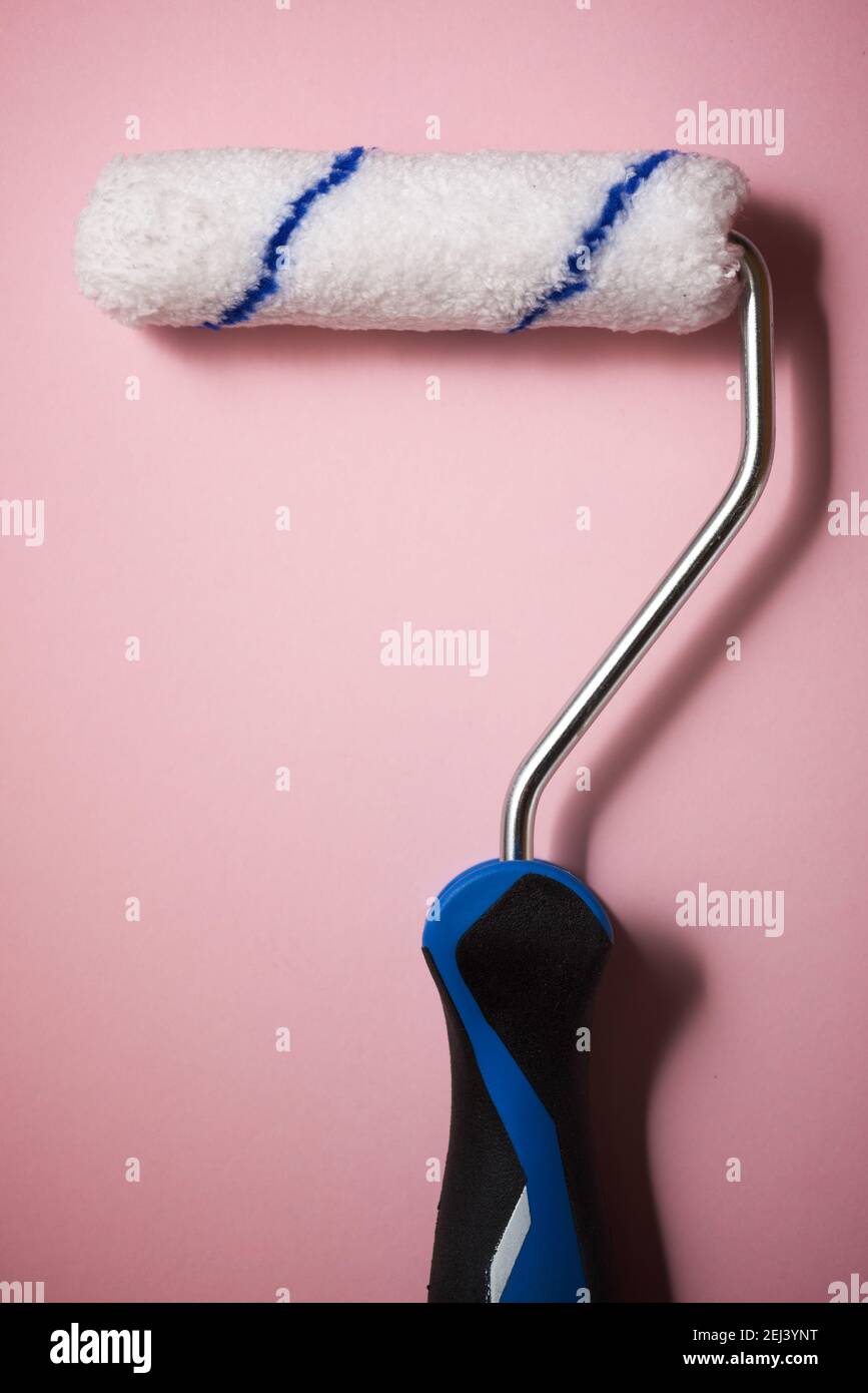 Paint roller on a pink table Stock Photo - Alamy