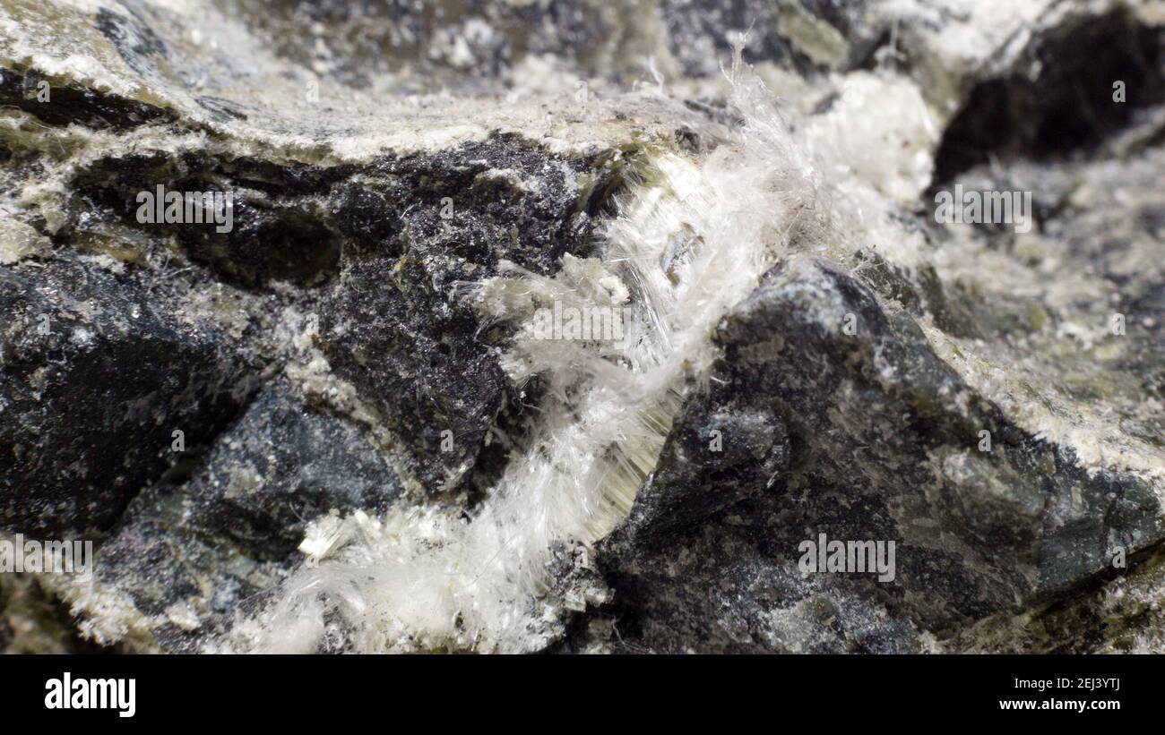 White fibers asbestos mineral in stone, close-up Stock Photo - Alamy