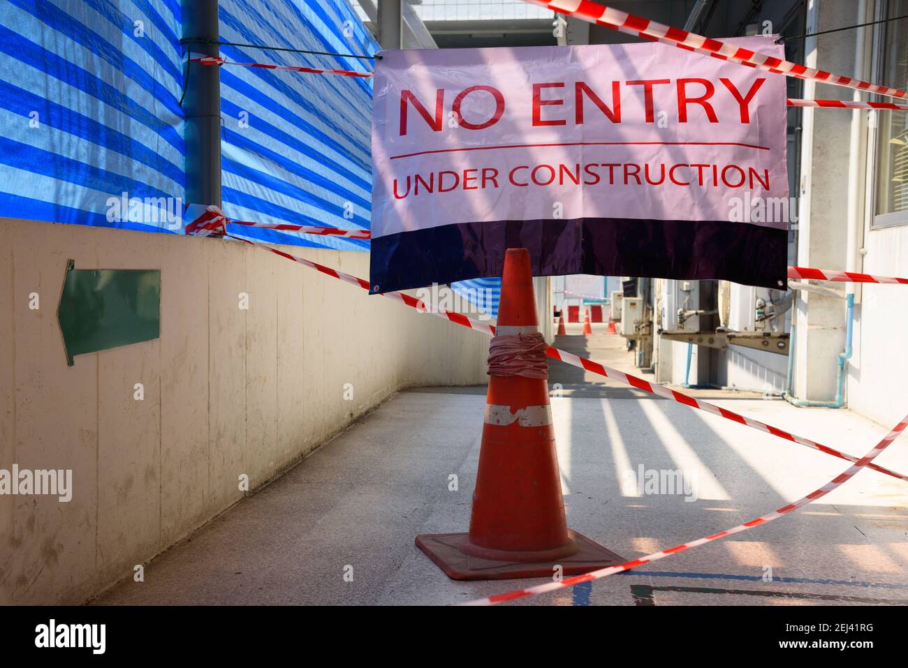 No entry sign hanging on the walkway in front of construction site ...