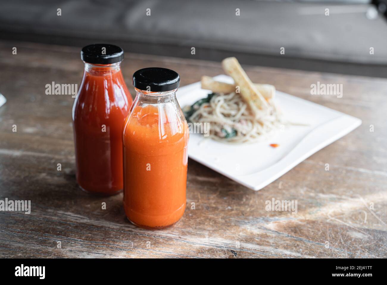 Two bottles of chilli sauce and tomato ketchup served along with the ...