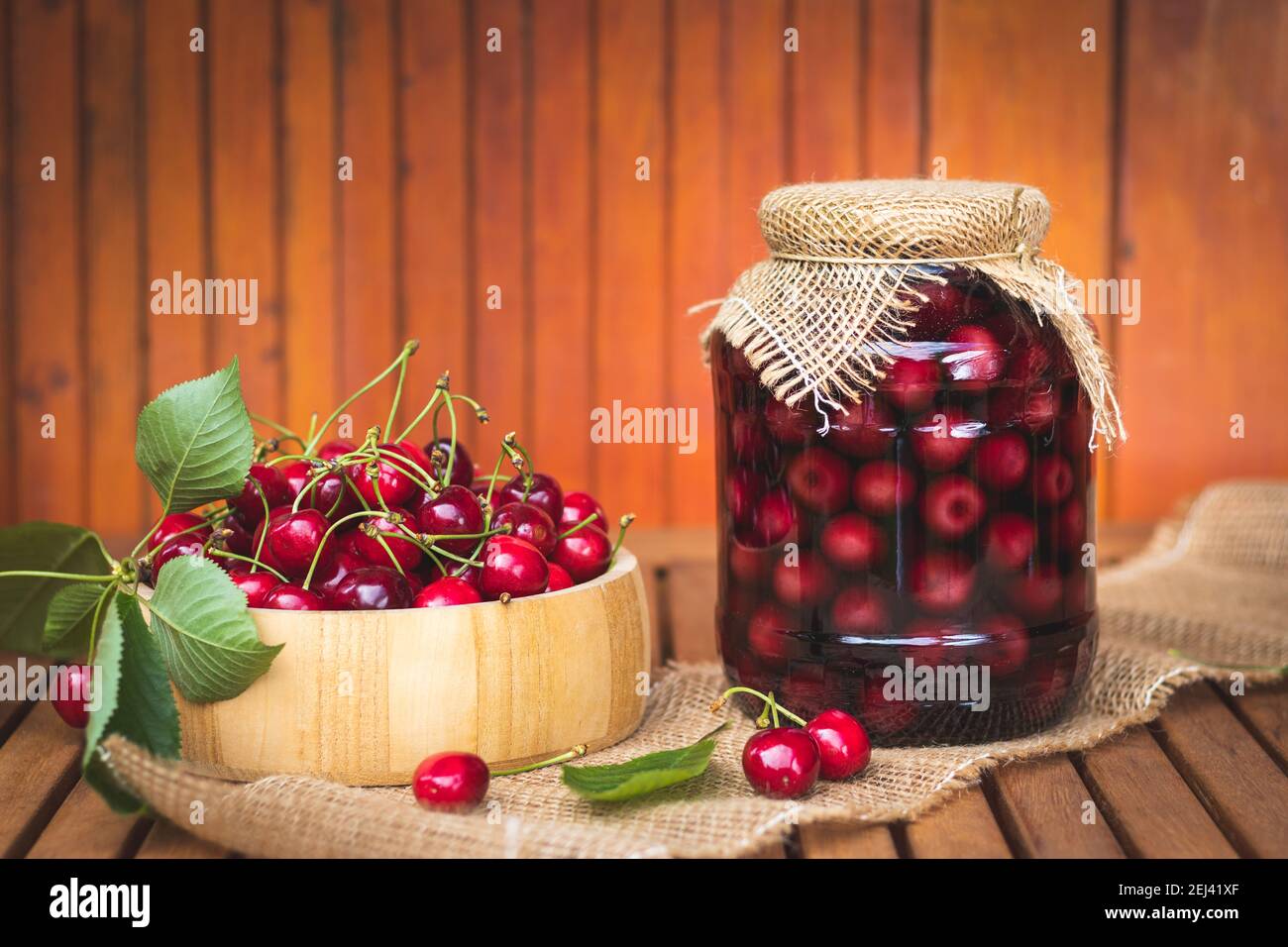 Homemade preserved cherry fruit in jar and fresh harvested ripe ...