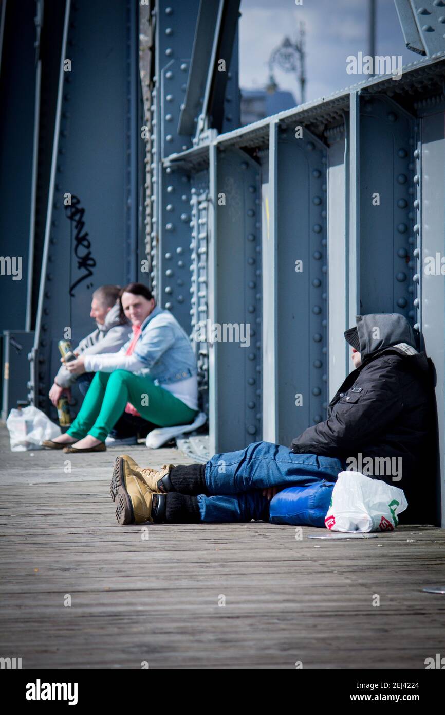A homeless man lying on the side of the road spends the day Stock Photo ...