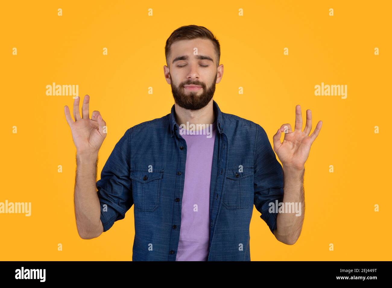 Stress relief concept. Handsome young man meditating with closed eyes ...