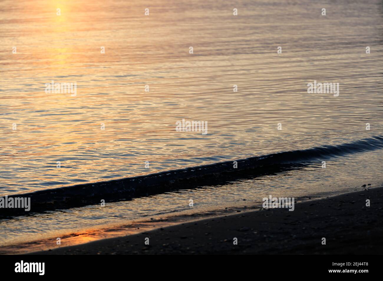 Soft wave at beach sunset Stock Photo - Alamy