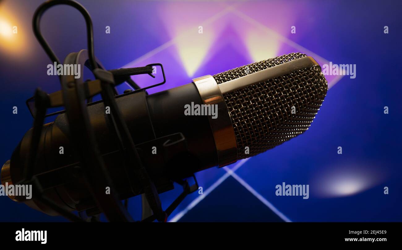 A wide-angle view of a microphone with a pedestal at a party atmosphere ...