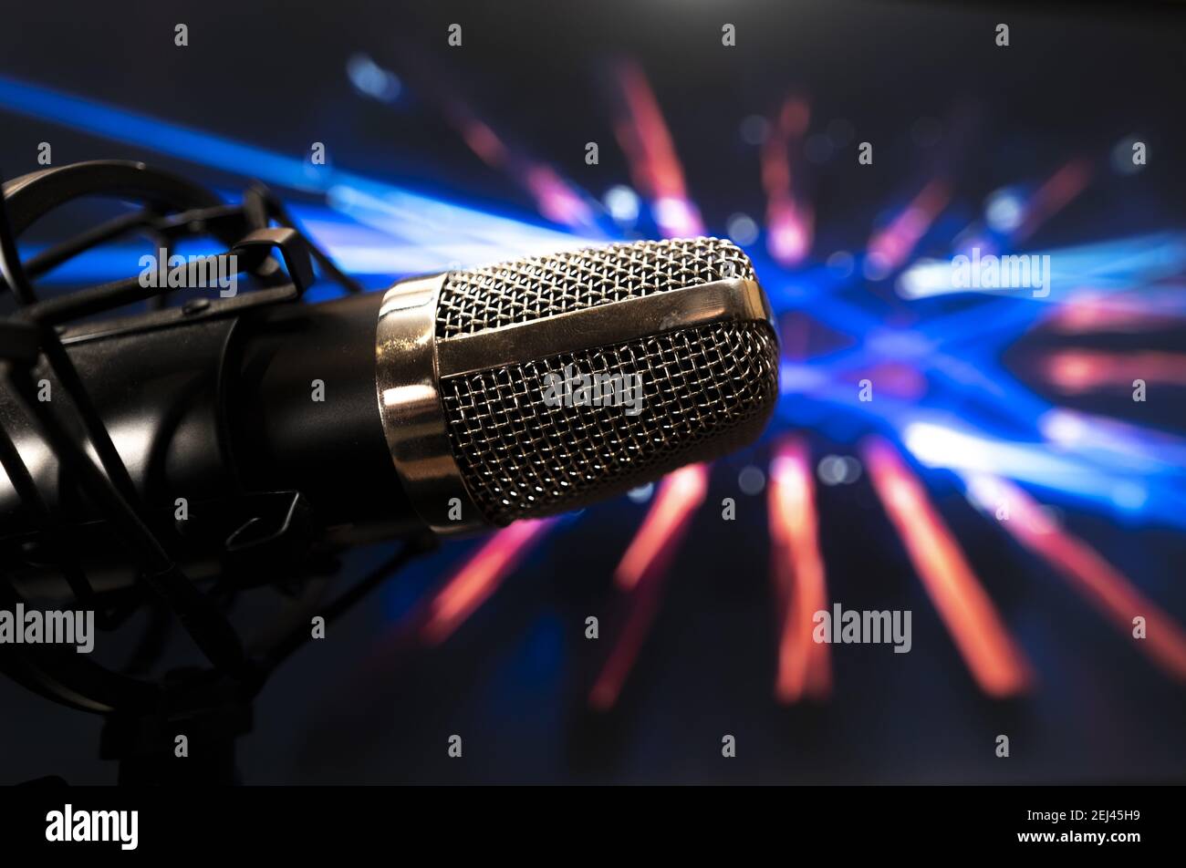 A wide-angle view of a microphone with a pedestal at a party atmosphere ...