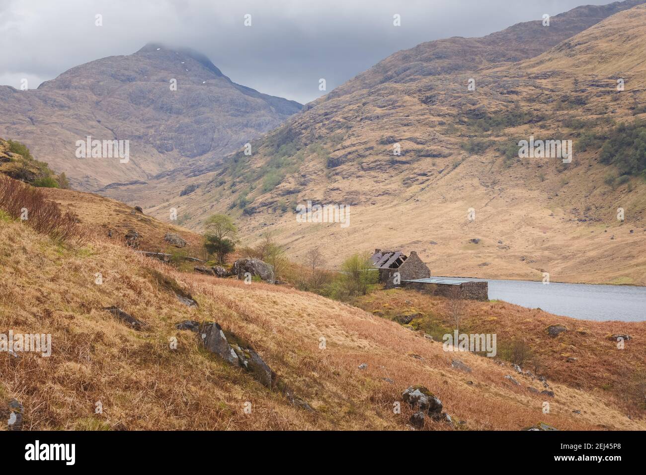 An isolated stone bothy in a moody mountain landscape on the remote and ...