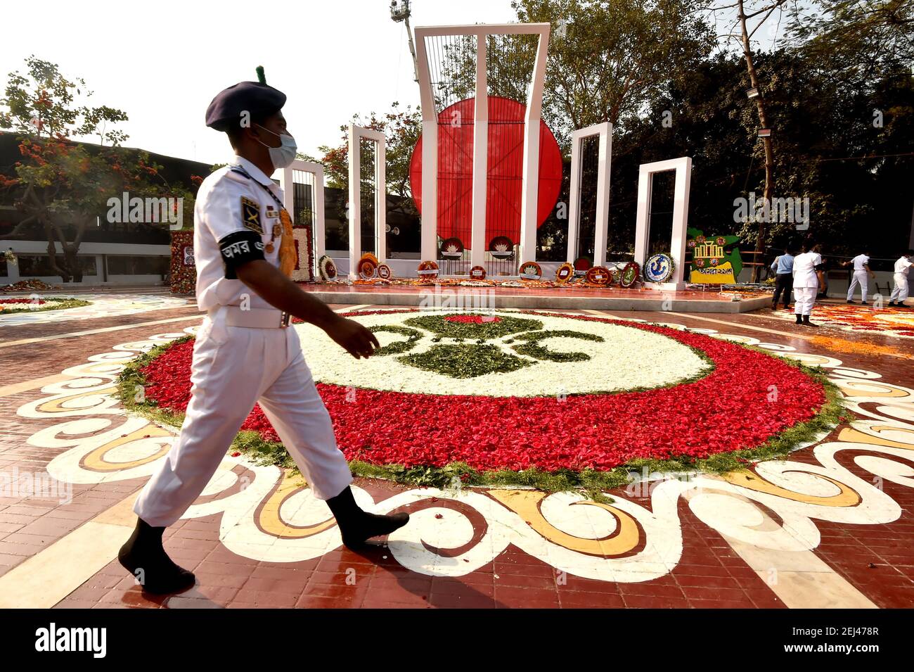 Dhaka. 21st Feb, 2021. A man walks past the decoration in front of the ...