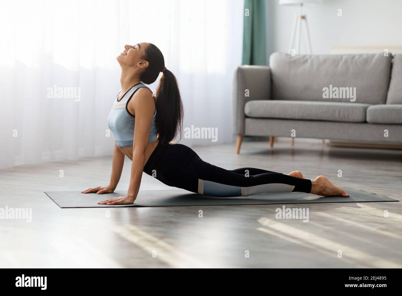 Flexible young woman exercising hi-res stock photography and images - Alamy