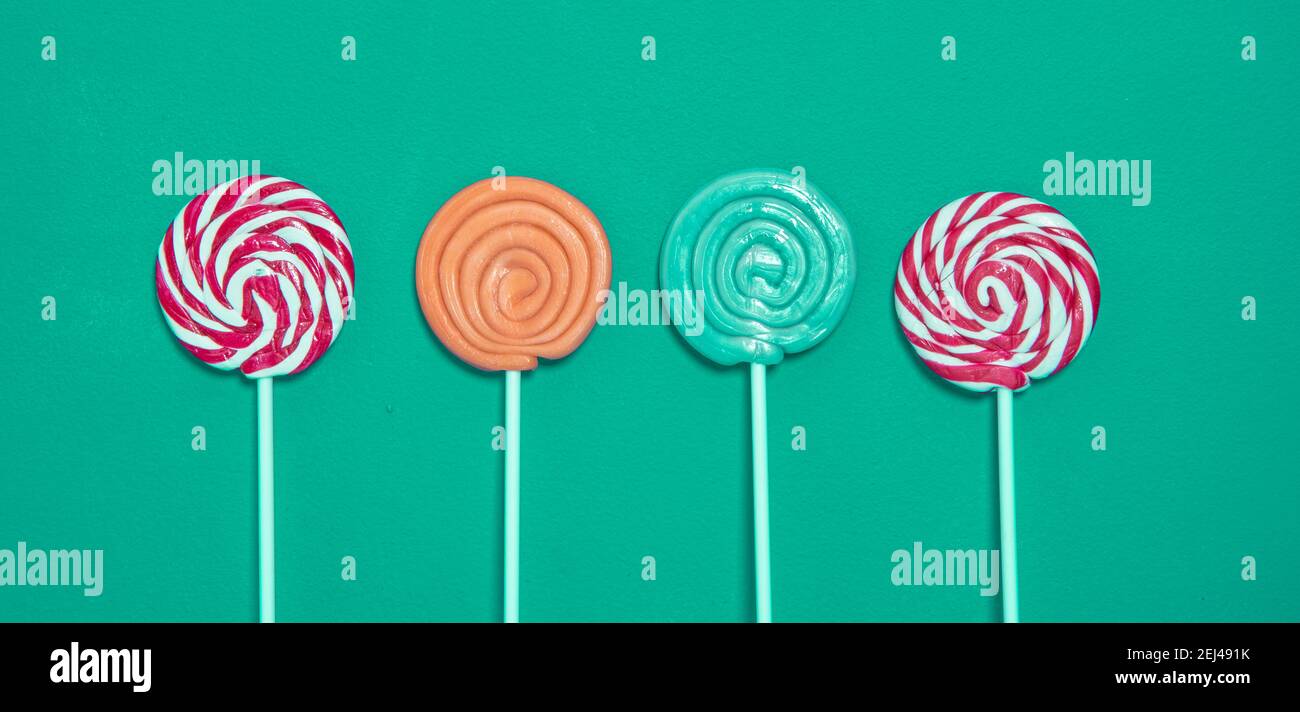 color lollipops on blue background Stock Photo - Alamy