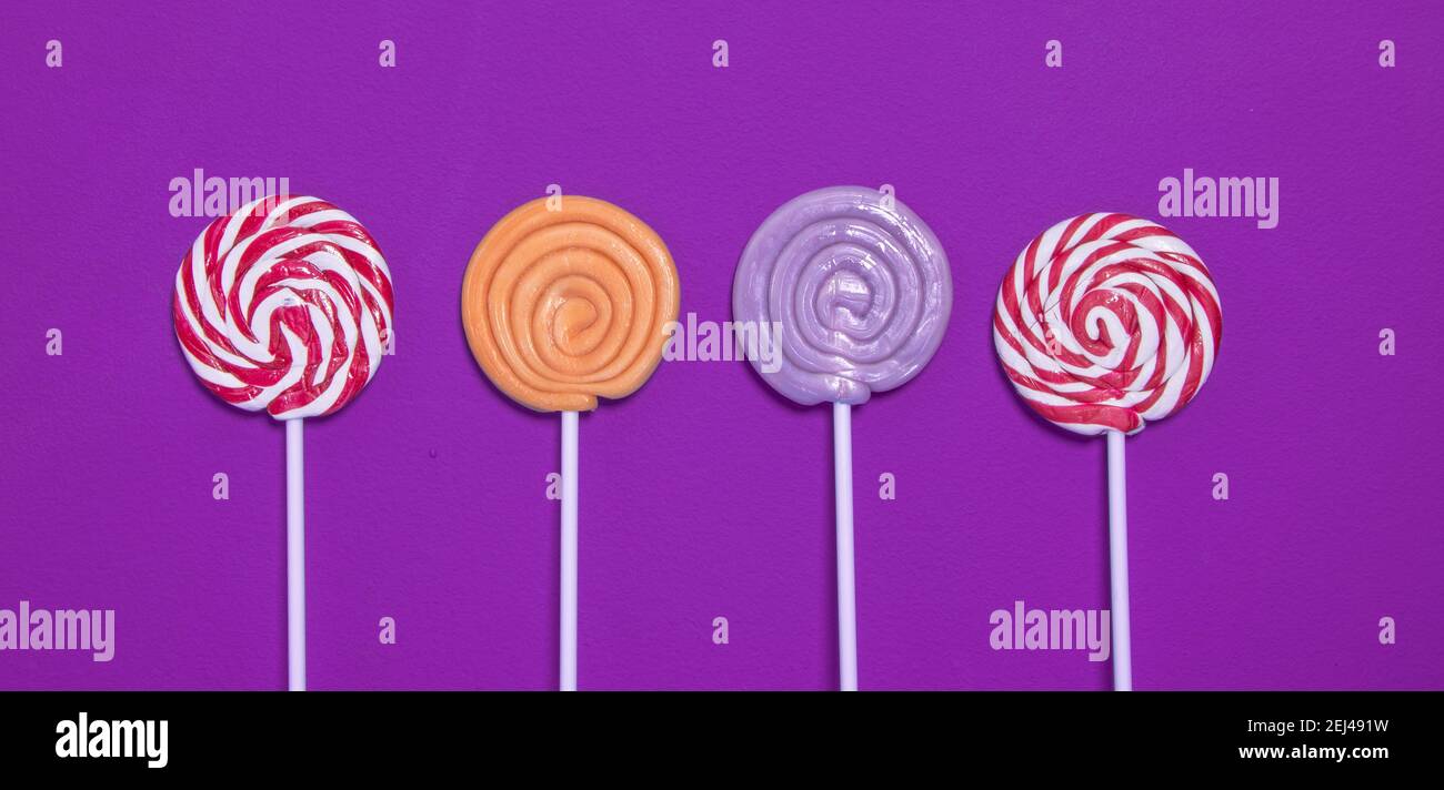 color lollipops on blue background Stock Photo - Alamy