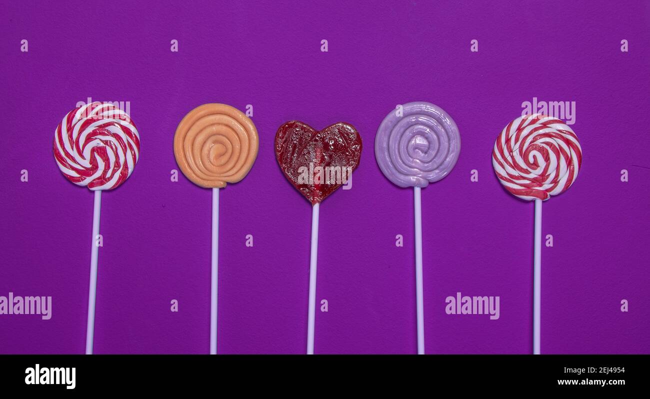color lollipops on blue background Stock Photo - Alamy