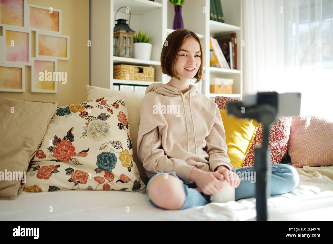 Beautiful teenage girl recording video blog with her smartphone. Young ...