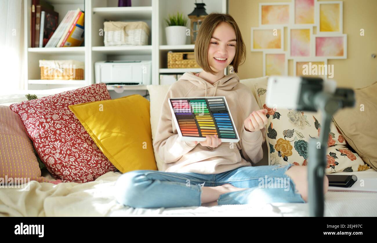 Beautiful teenage girl recording video blog with her smartphone. Young ...