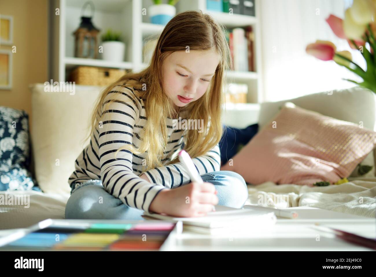Cute young girl writing letter at home. Child doing her homework in her ...