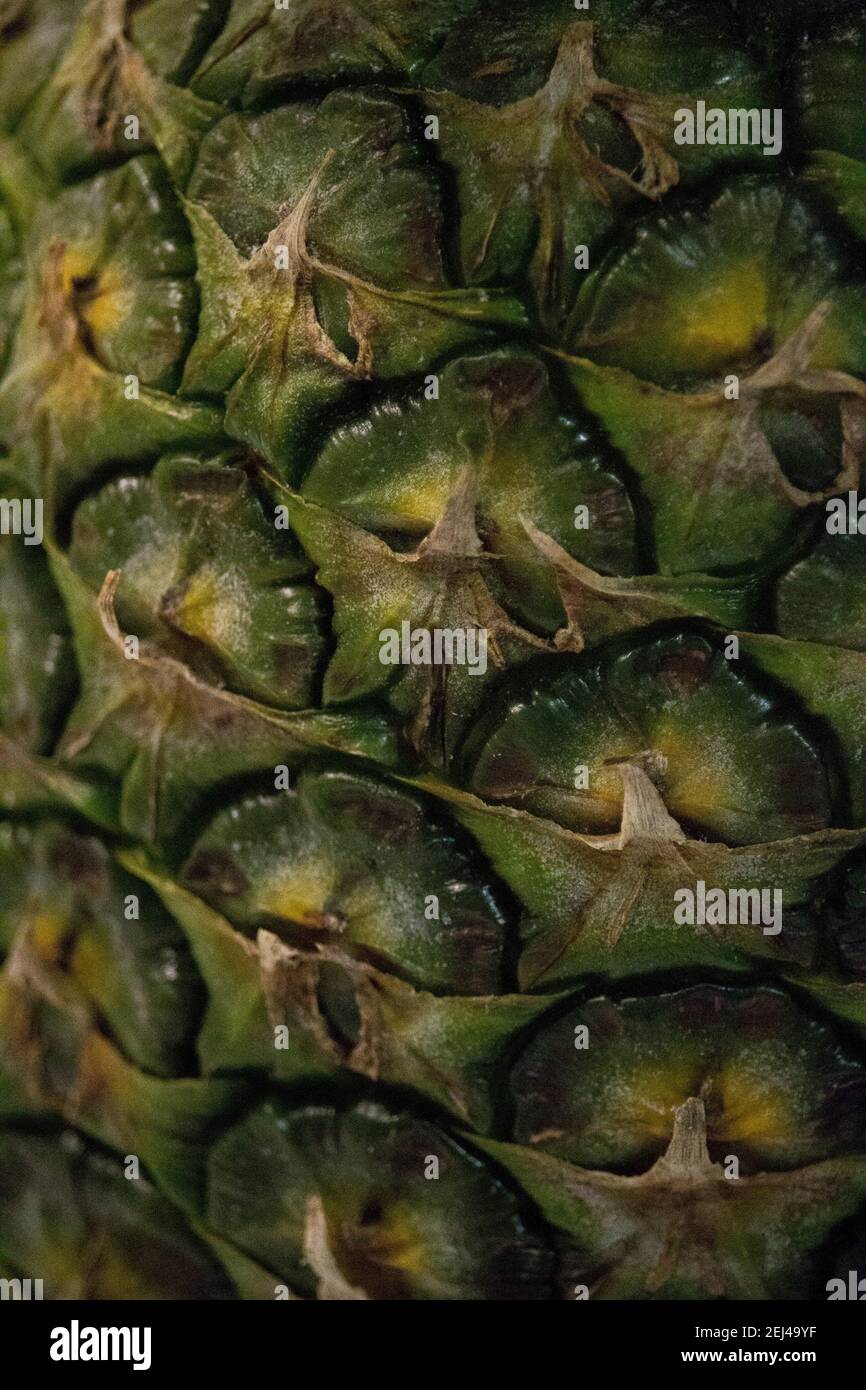 A closeup view of the pineapple part with a yellow and green coloration ...