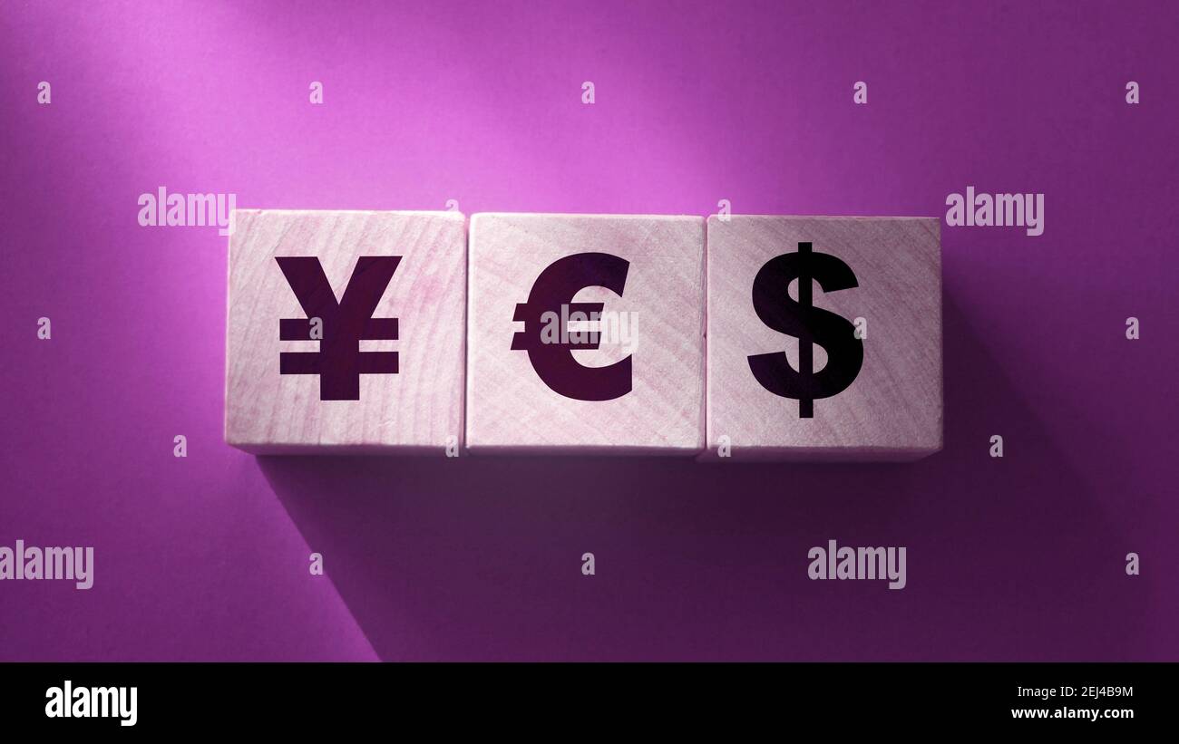 World currencies symbols - yen, euro and dollar printed on wooden cubes ...