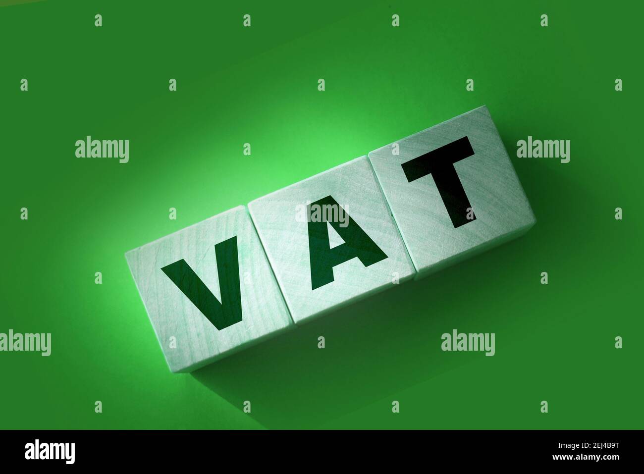 Vat on wooden cubes over red background with copy space, financial ...