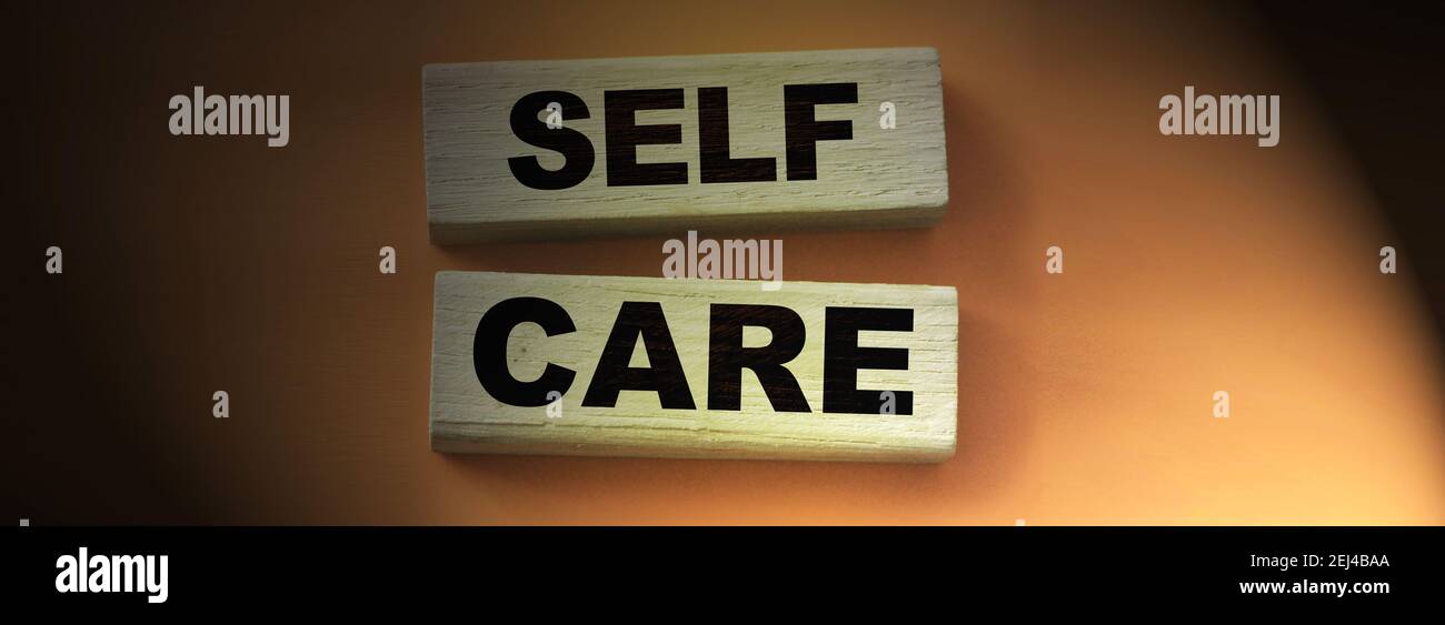 SELF CARE - text on wooden cubes on a red gradient background Stock ...