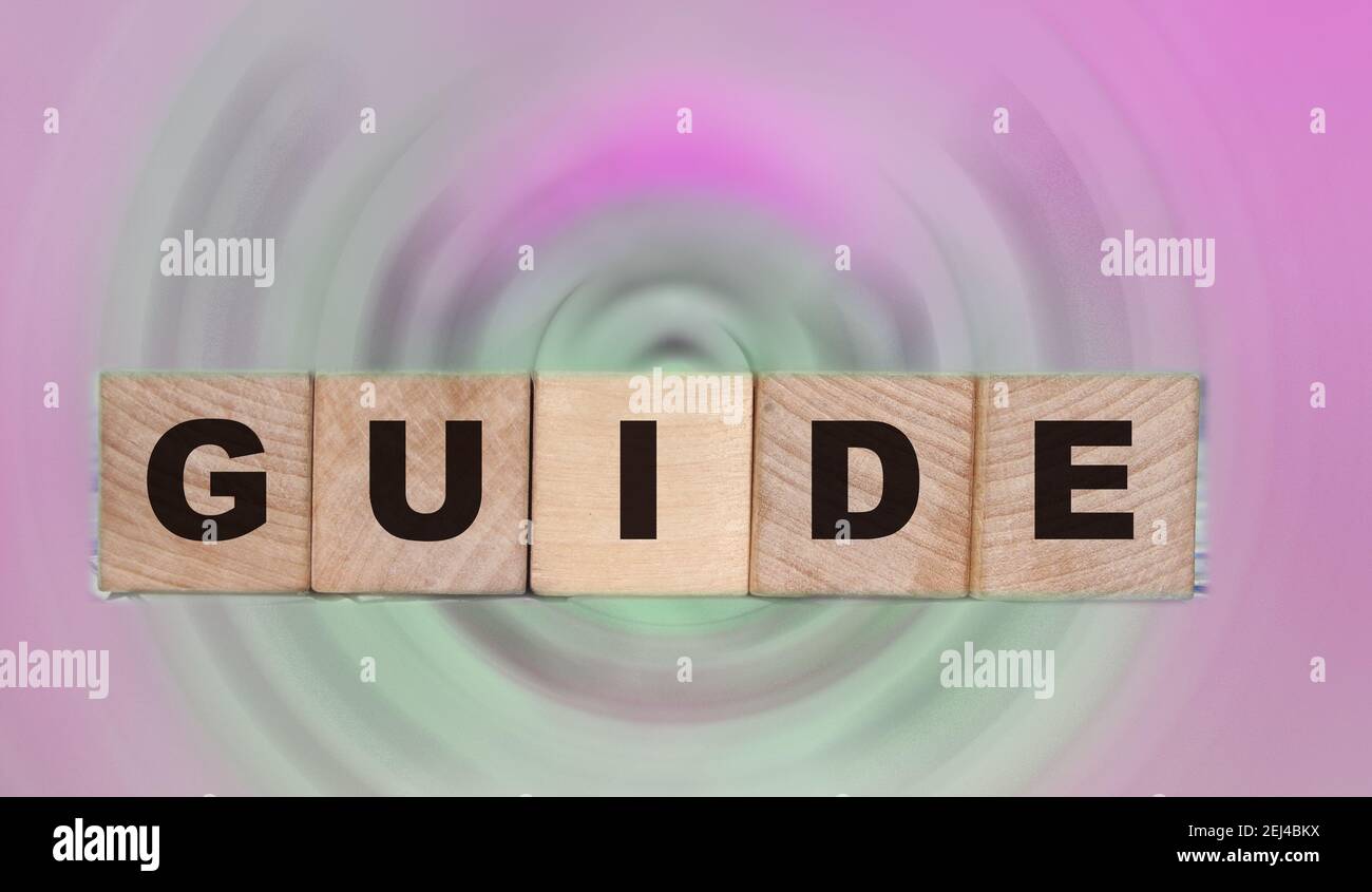Guide Word Written In Wooden Cubes on relaxed beach landscape ...