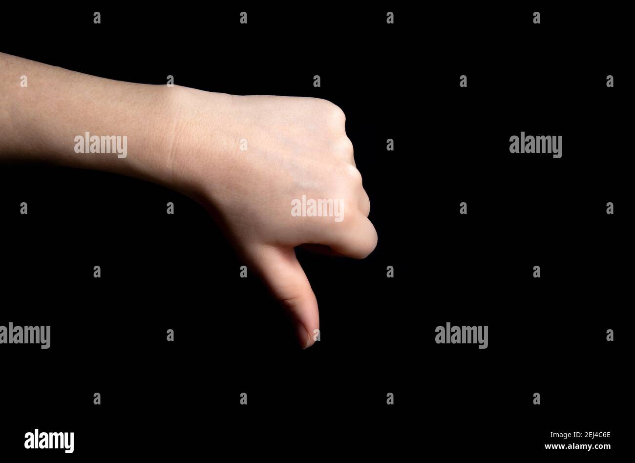 Thumb down sign hand gesture on dark black background, Review, business ...