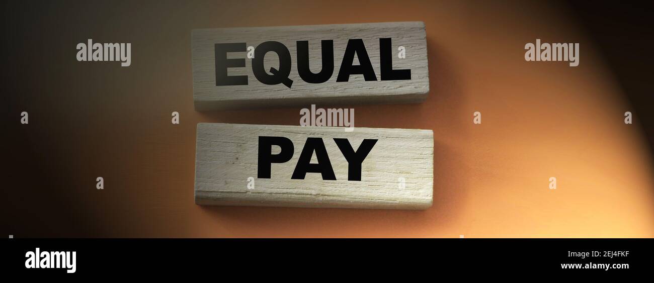 Equal pay words on wooden blocks. Income differences between men and ...