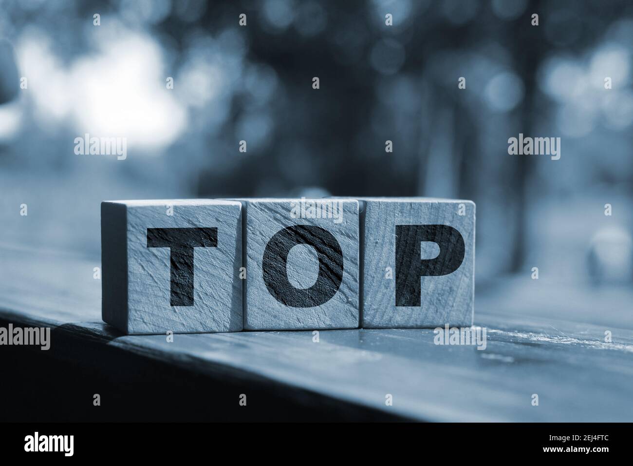 Wooden cubes arranged in three with copy space and nature blured ...