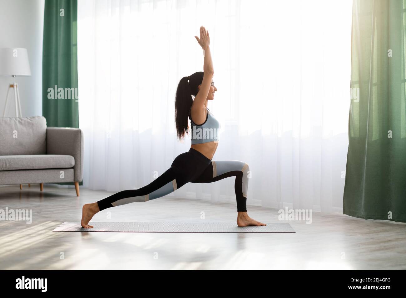 Yoga woman exercising at home, side view Stock Photo - Alamy